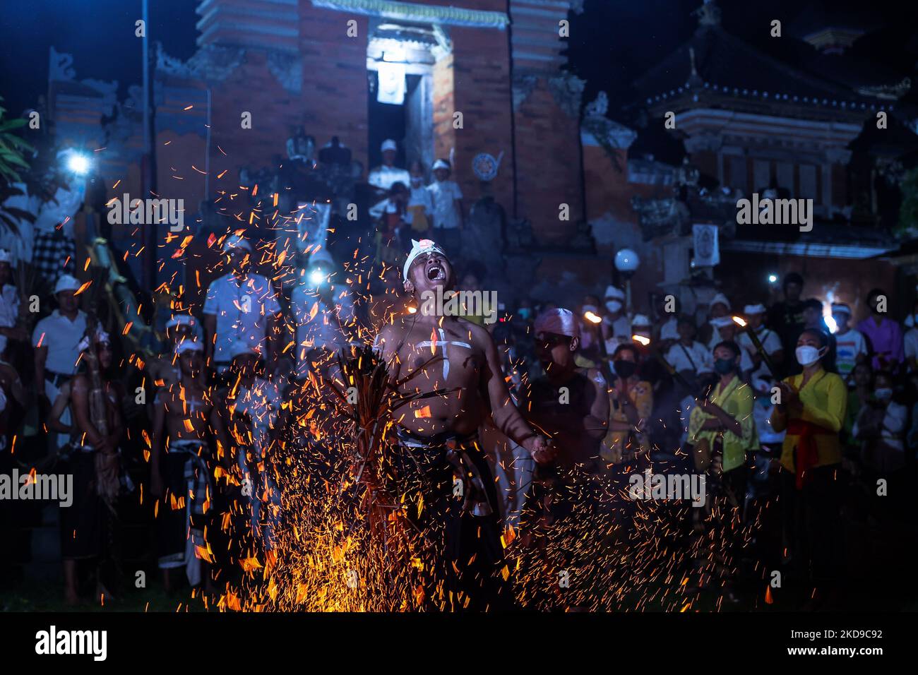 A Balinese man is hit with burning dried coconut leaves during a fire ...