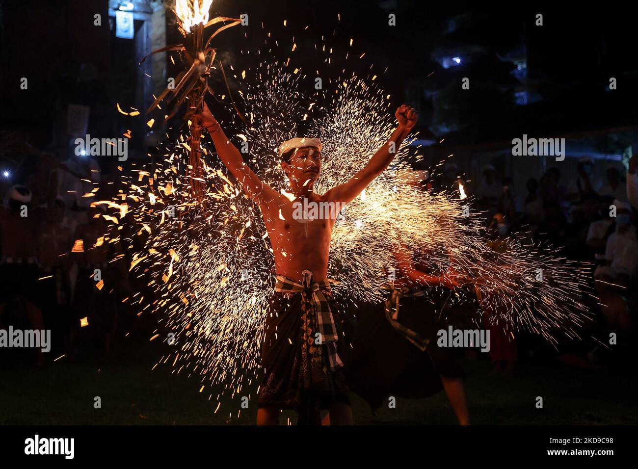 A Balinese man is hit with burning dried coconut leaves during a fire ...