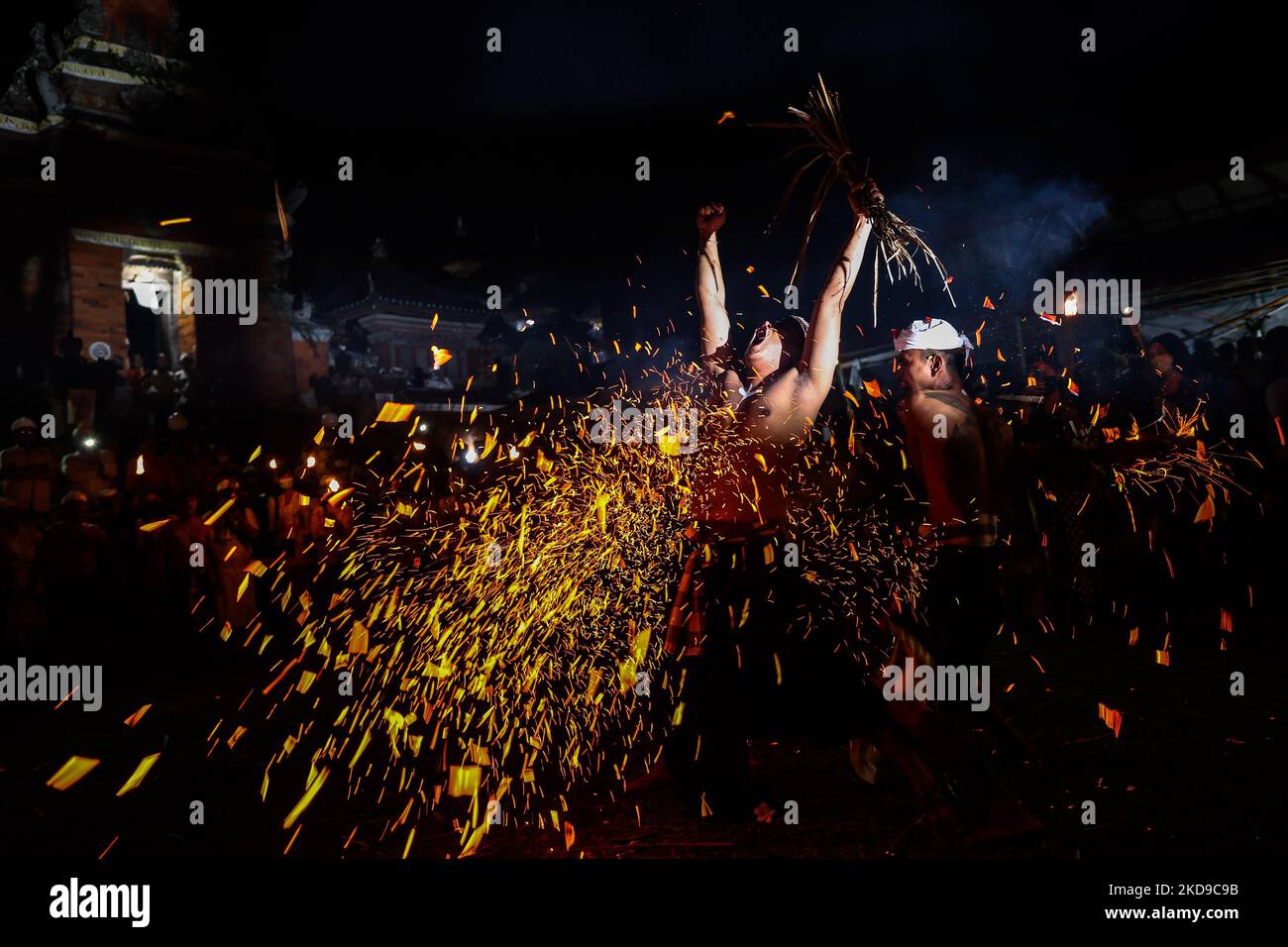 A Balinese man is hit with burning dried coconut leaves during a fire ...