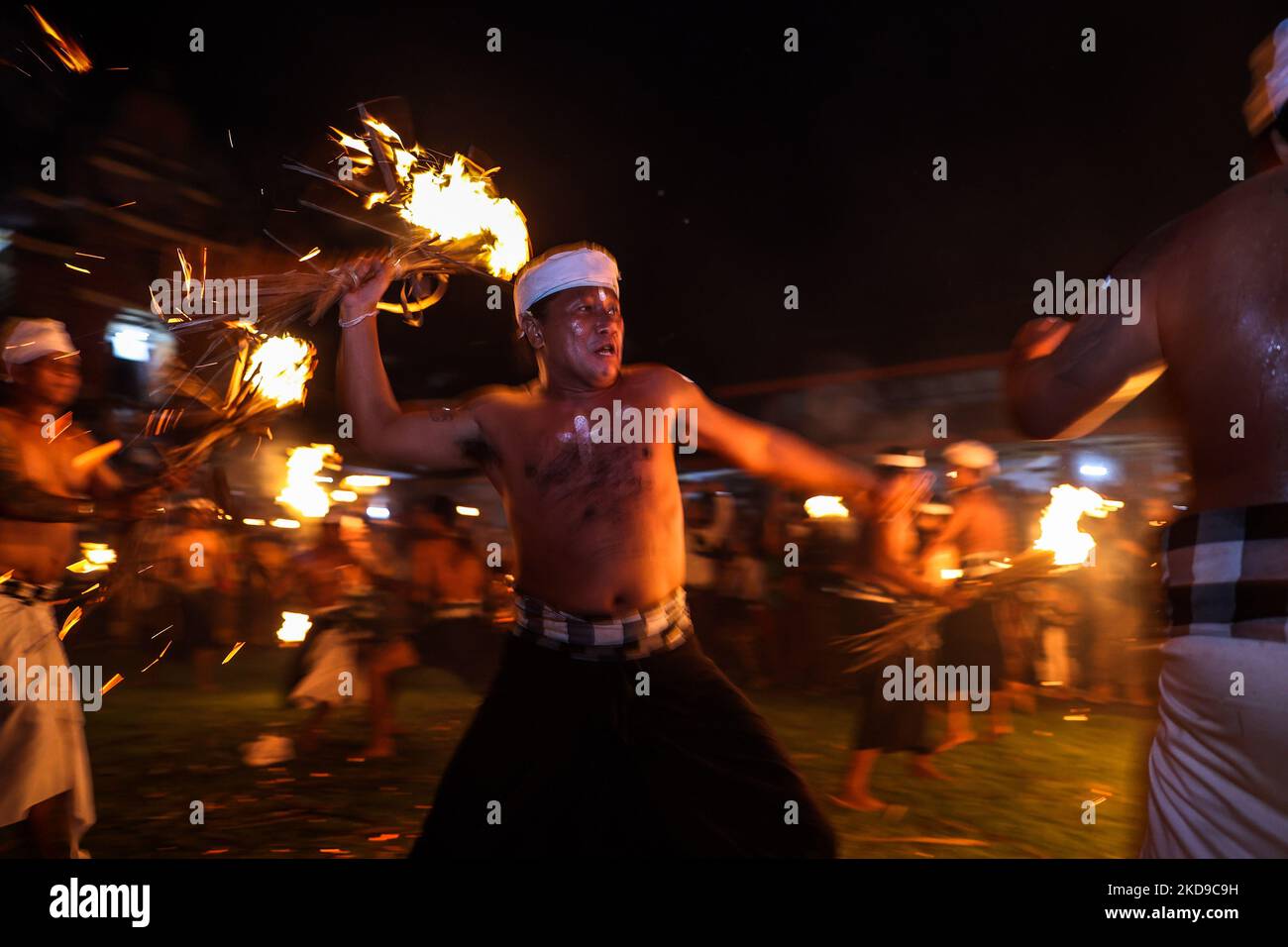 A Balinese man is hit with burning dried coconut leaves during a fire ...