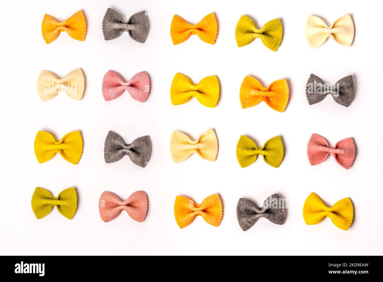 colored farfalle pasta isolated on a white background Stock Photo - Alamy