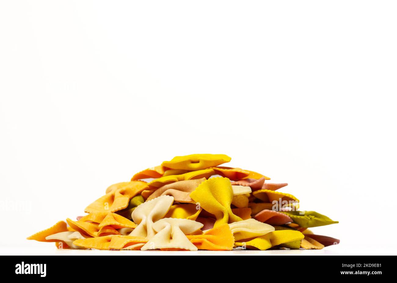 colored farfalle pasta isolated on a white background Stock Photo - Alamy