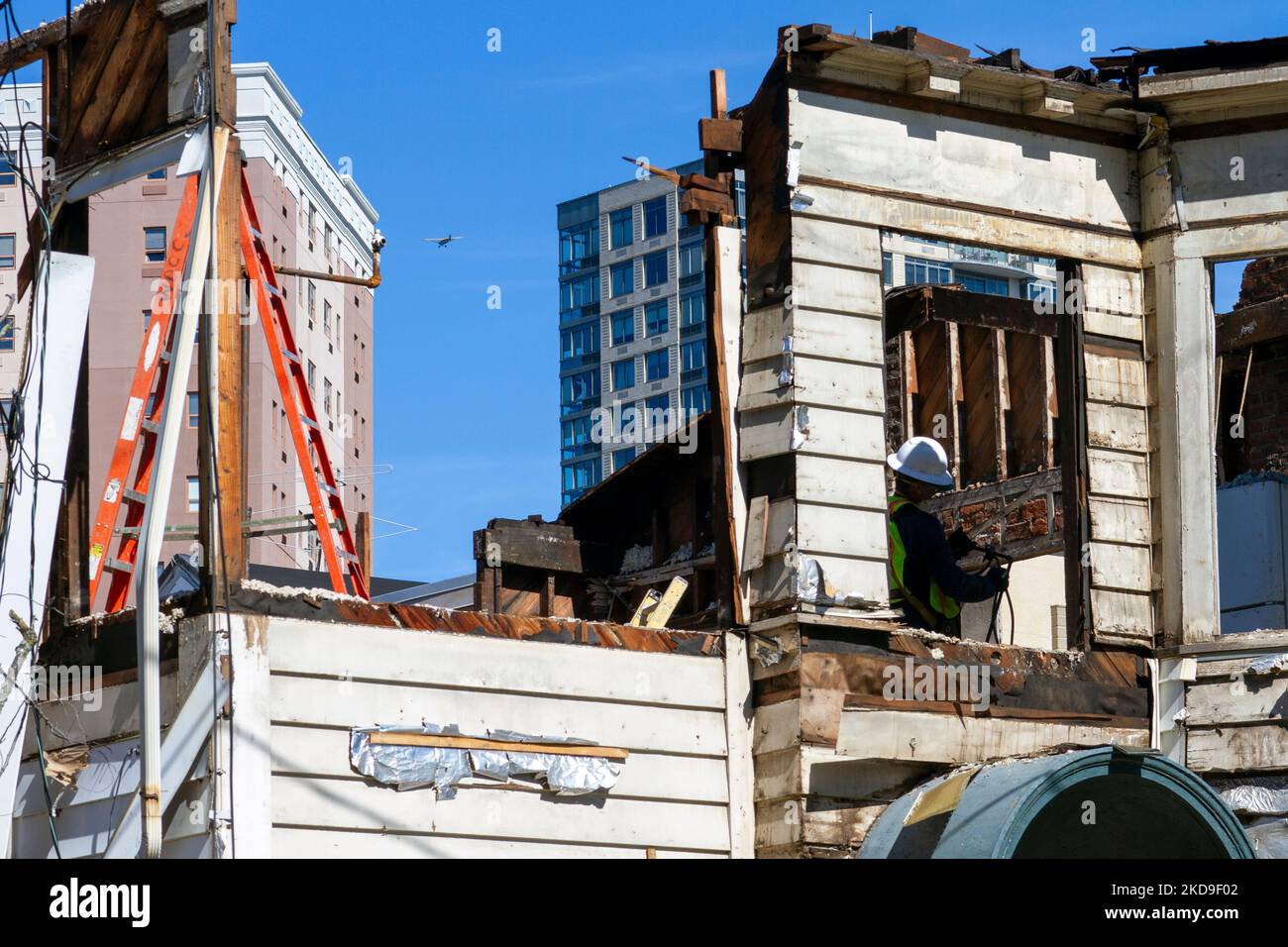 Man working on tearing down a house in New Brunswick, NJ Stock Photo ...