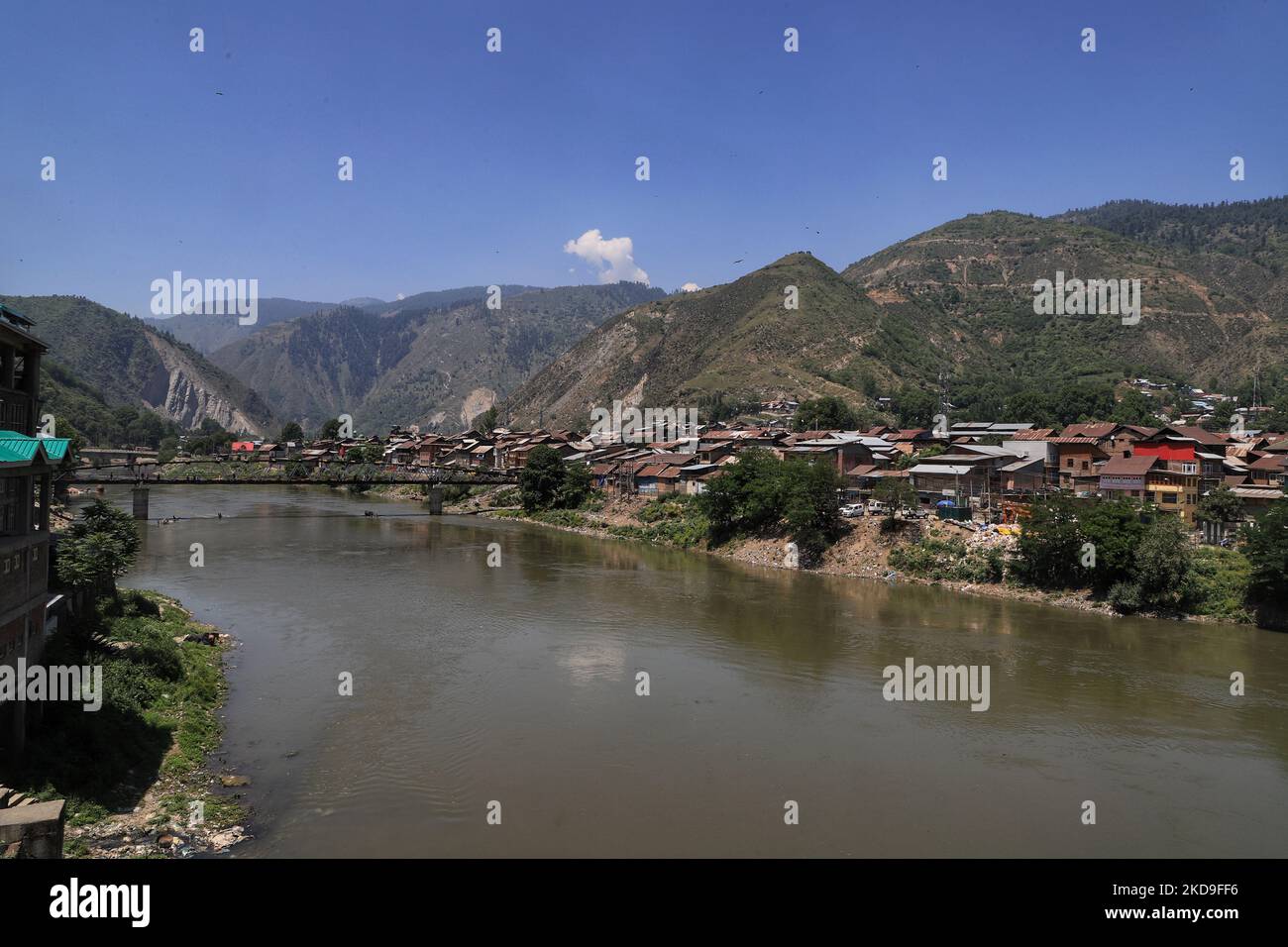 Residential houses are seen on the banks of River Jhelum in Baramulla ...