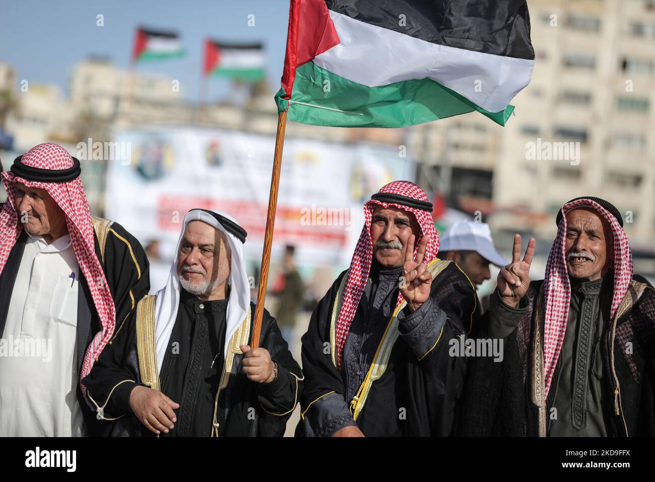 Palestinians gather with national flags along a beach as they mark ...