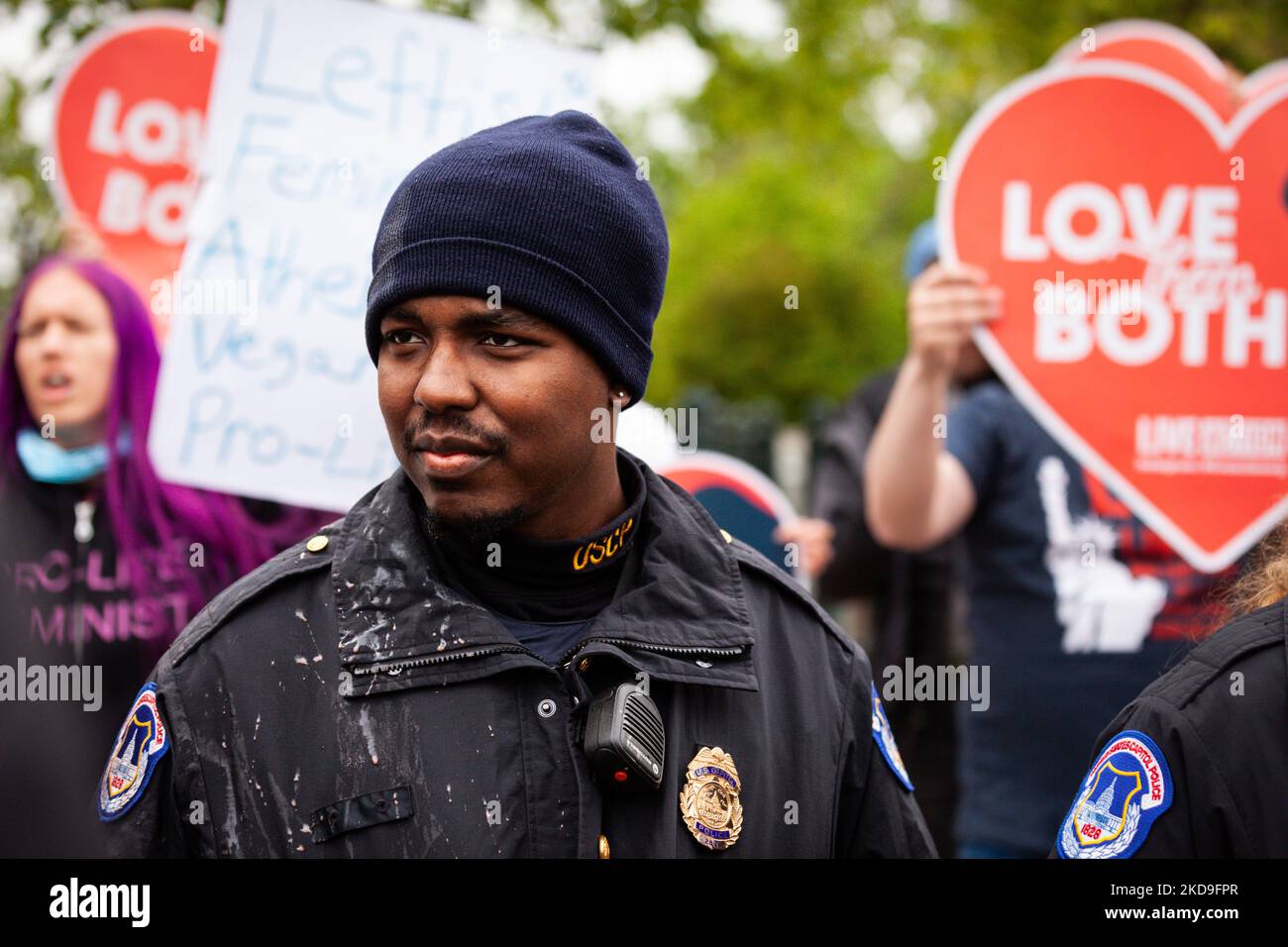 A Capitol Police officer stands guard after being hit by a flying cup ...