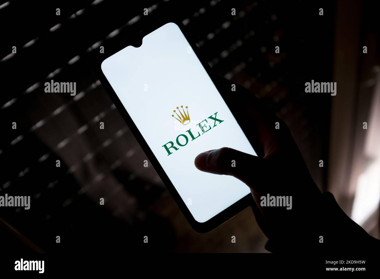 In this photo illustration a Rolex logo seen displayed on a smartphone ...