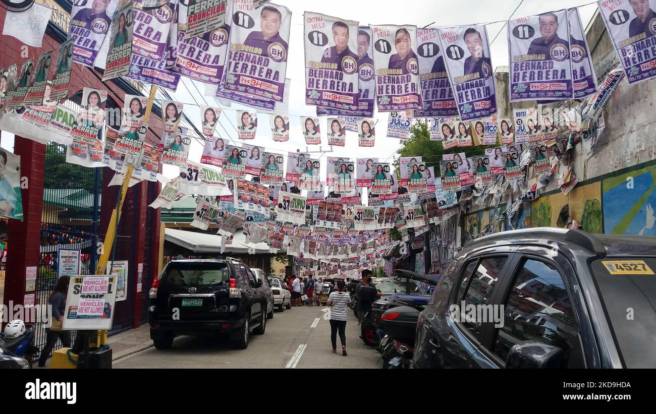 Election posters adorn the street leading to polling precincts inside a ...