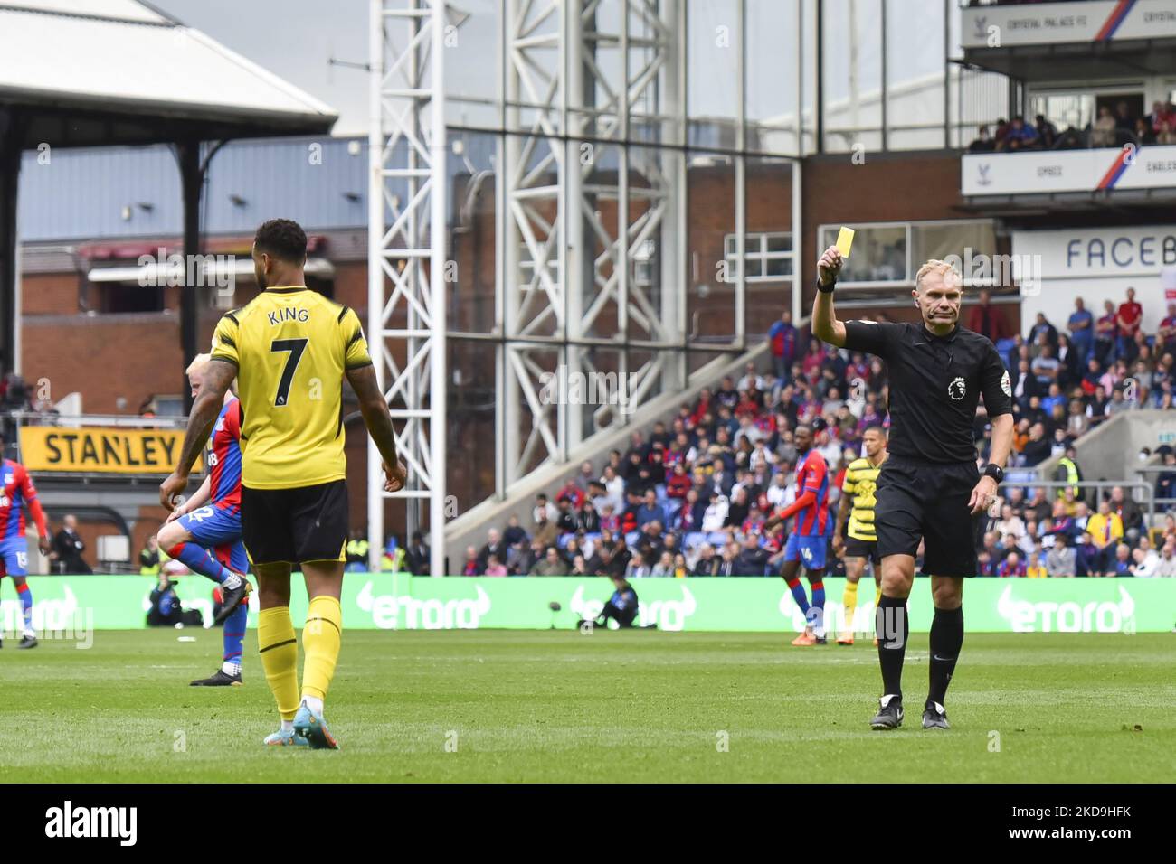 Joshua King of Watford is shown a yellow card by the referee Graham ...