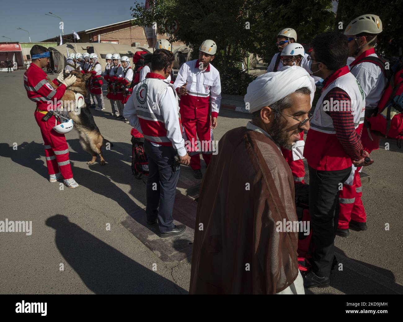 A member of the Iranian Red Crescent Society stands with a search and ...