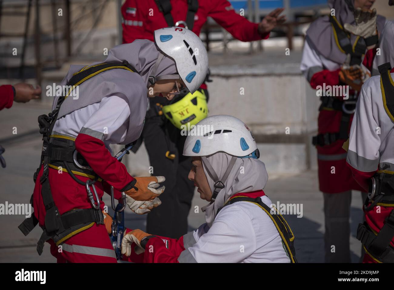 Two female members of the Iranian Red Crescent Society prepare to ...
