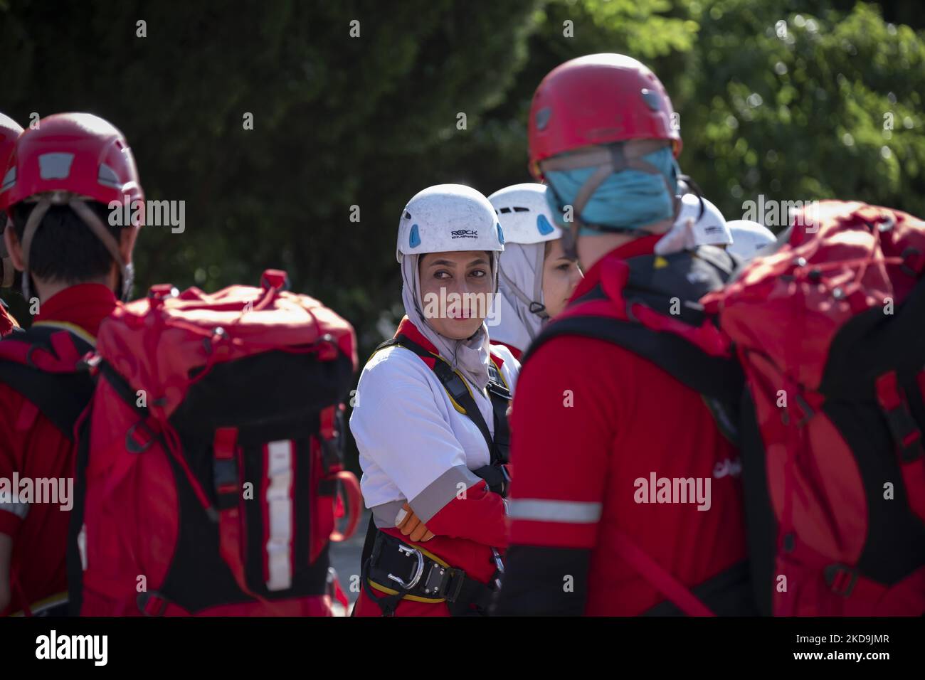 A female member of the Iranian Red Crescent Society looks on while ...