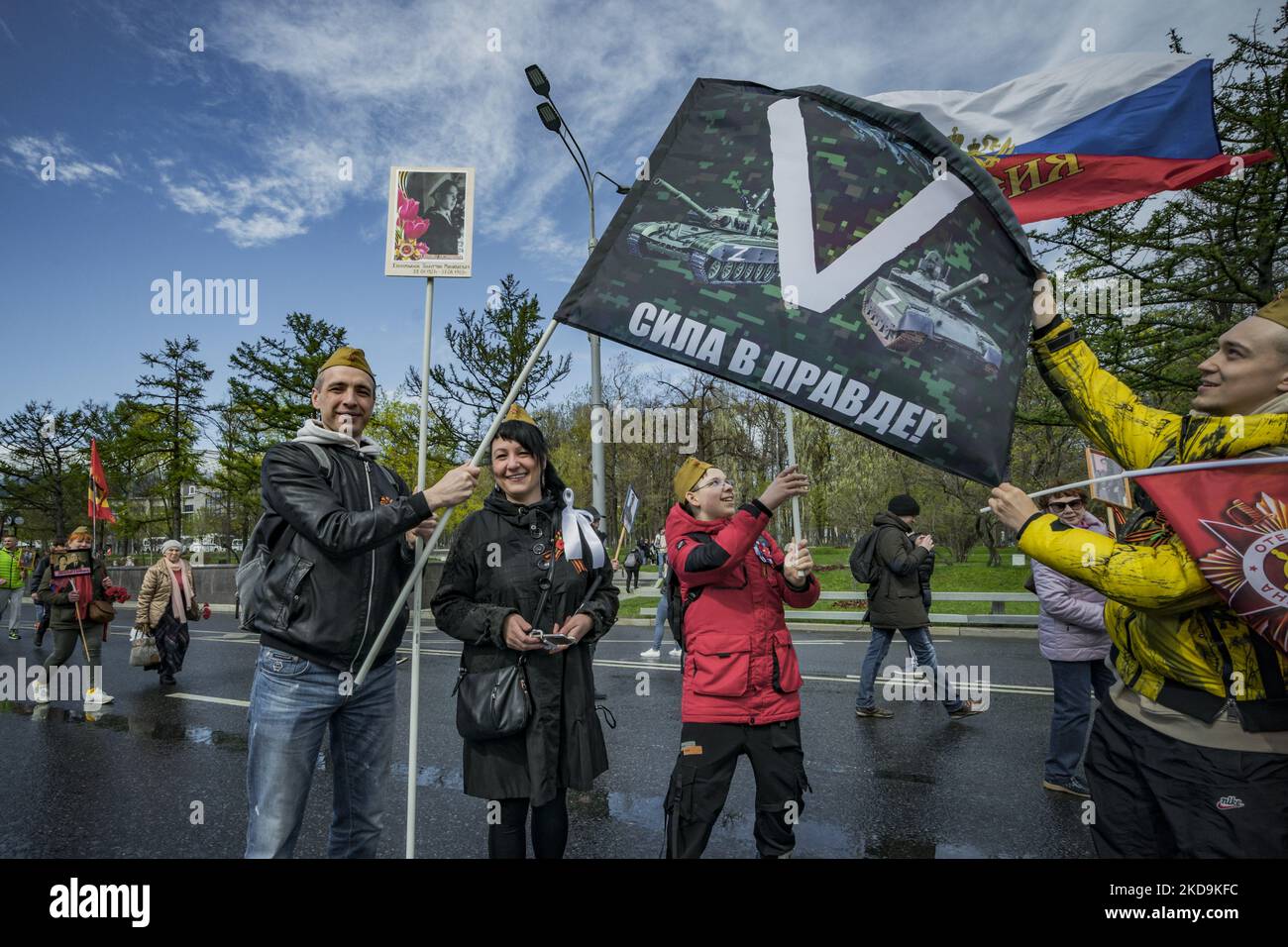 A man holds a flag with the "V" symbol, showing his support of the ...