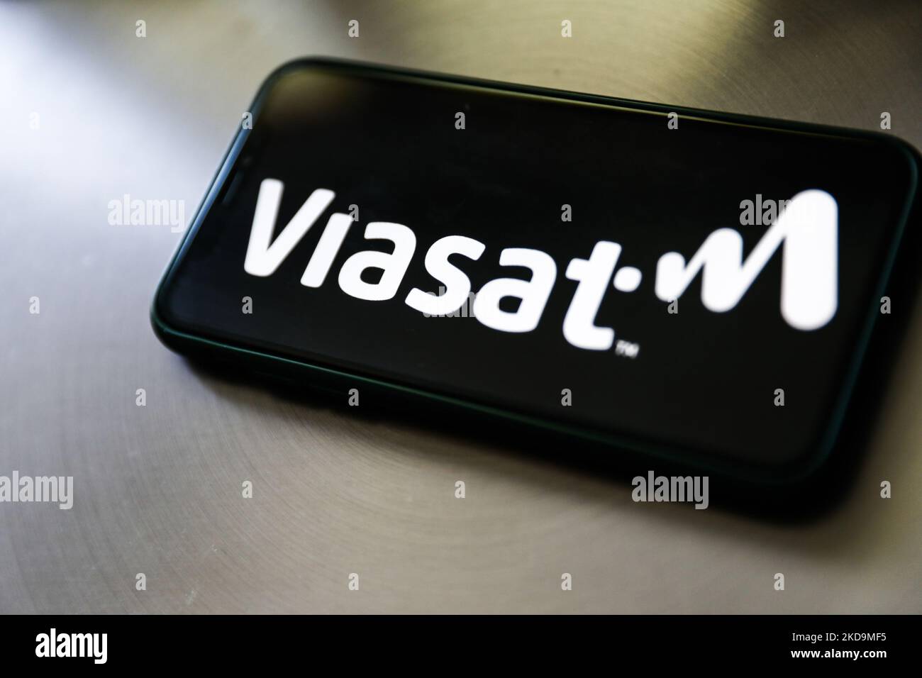 Viasat logo displayed on a phone screen is seen in this illustration ...