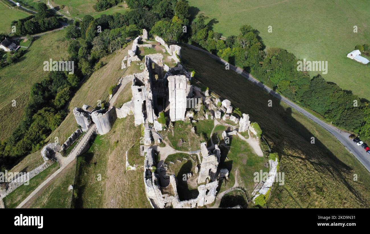 An aerial top view of the amazing and ancient Corfe Castle in England ...