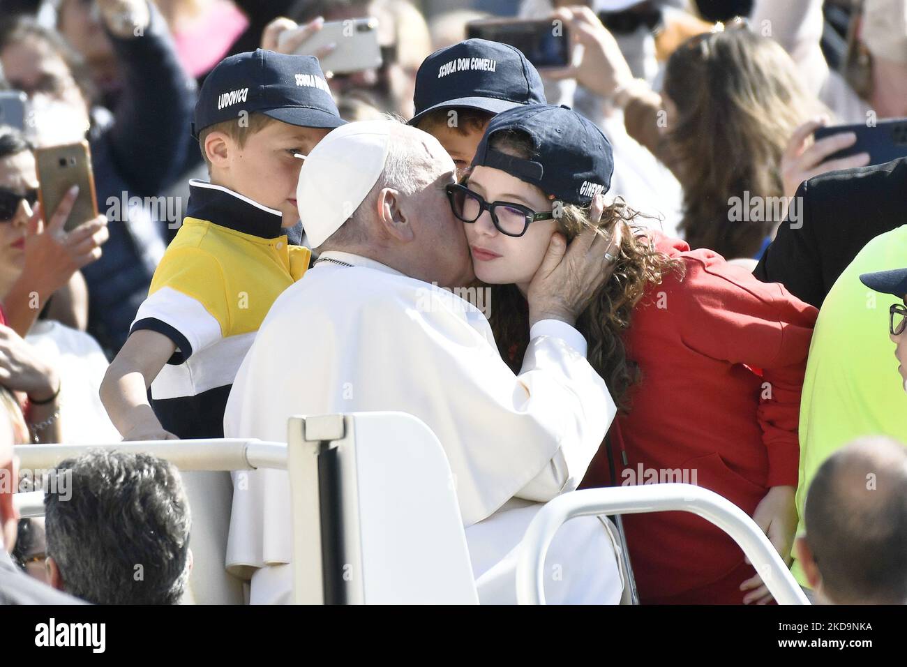 Pope Francis greets children as he arrives in St. Peter's Square on the ...