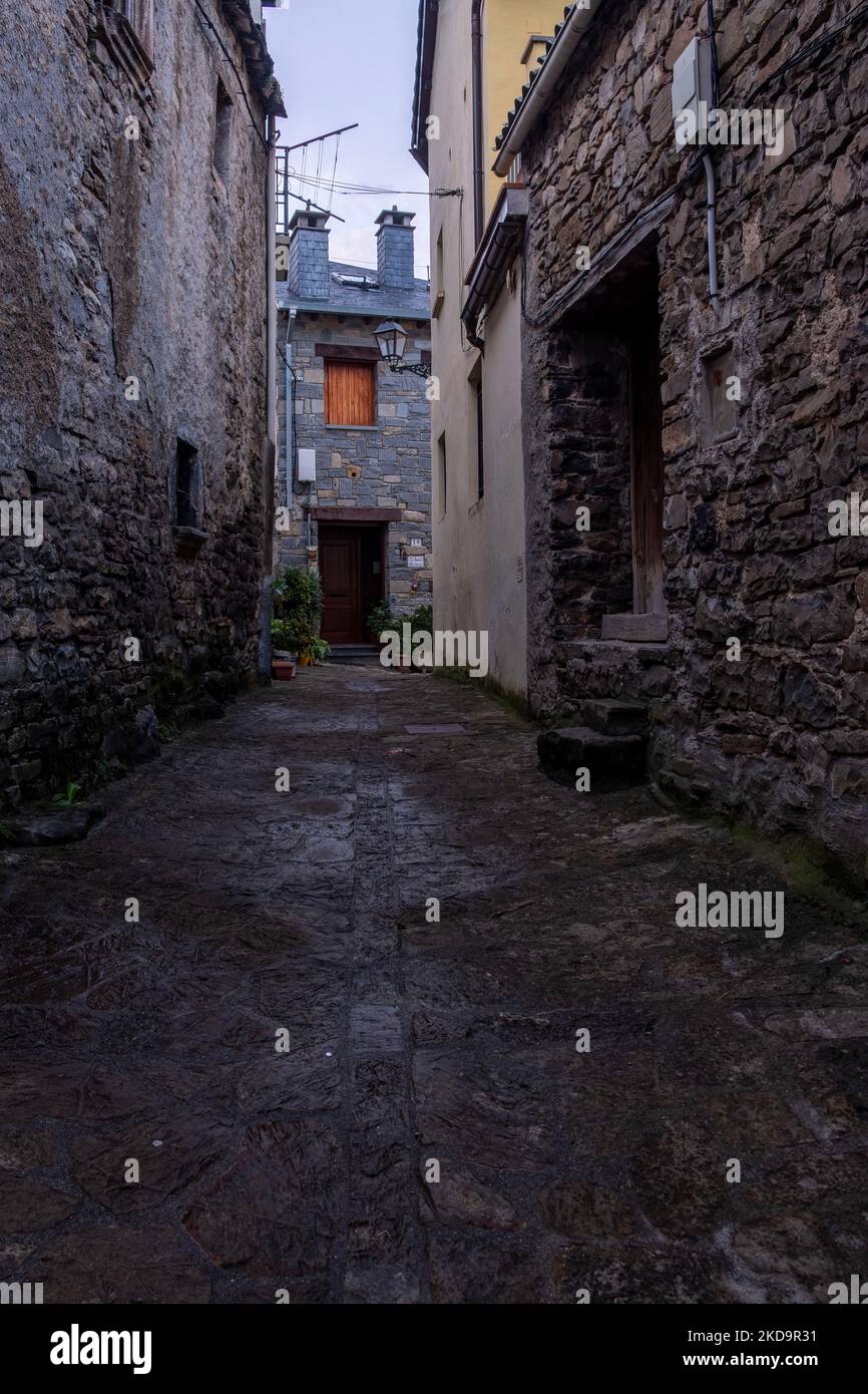 A narrow alley between medieval buildings in Torla-Ordesa municipality ...