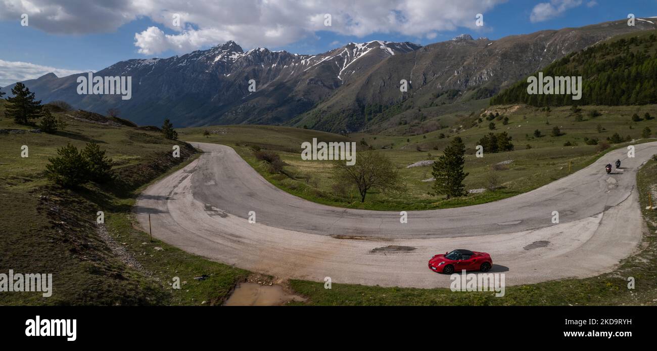 A drone view of an Alfa Romeo 4C in the roads of the Appennini ...
