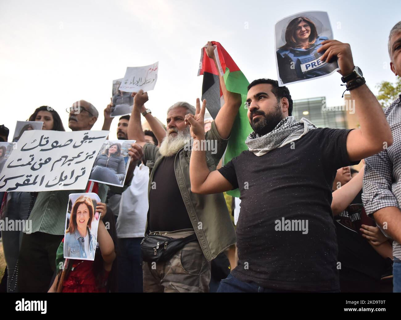 People take part in a candelight vigil outside the UN ESCWA building to ...