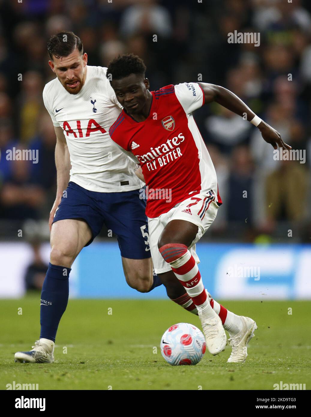 Bukayo Saka of Arsenal holds of Tottenham Hotspur's Pierre-Emile Hojbjerg during Premier League ...