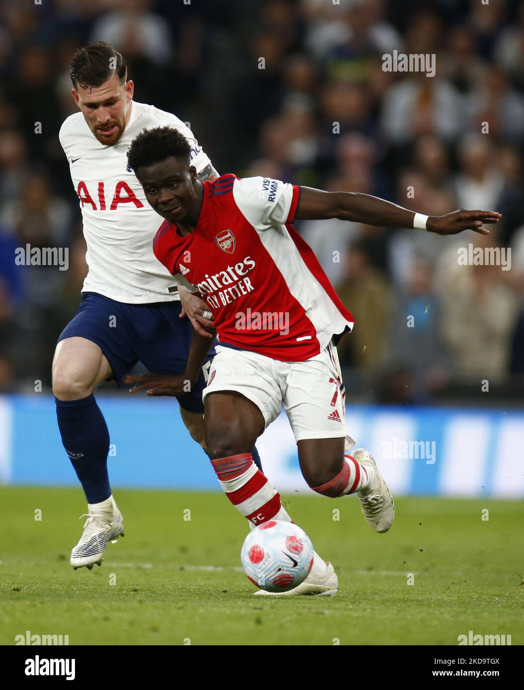 Bukayo Saka of Arsenal holds of Tottenham Hotspur's Pierre-Emile Hojbjerg during Premier League ...