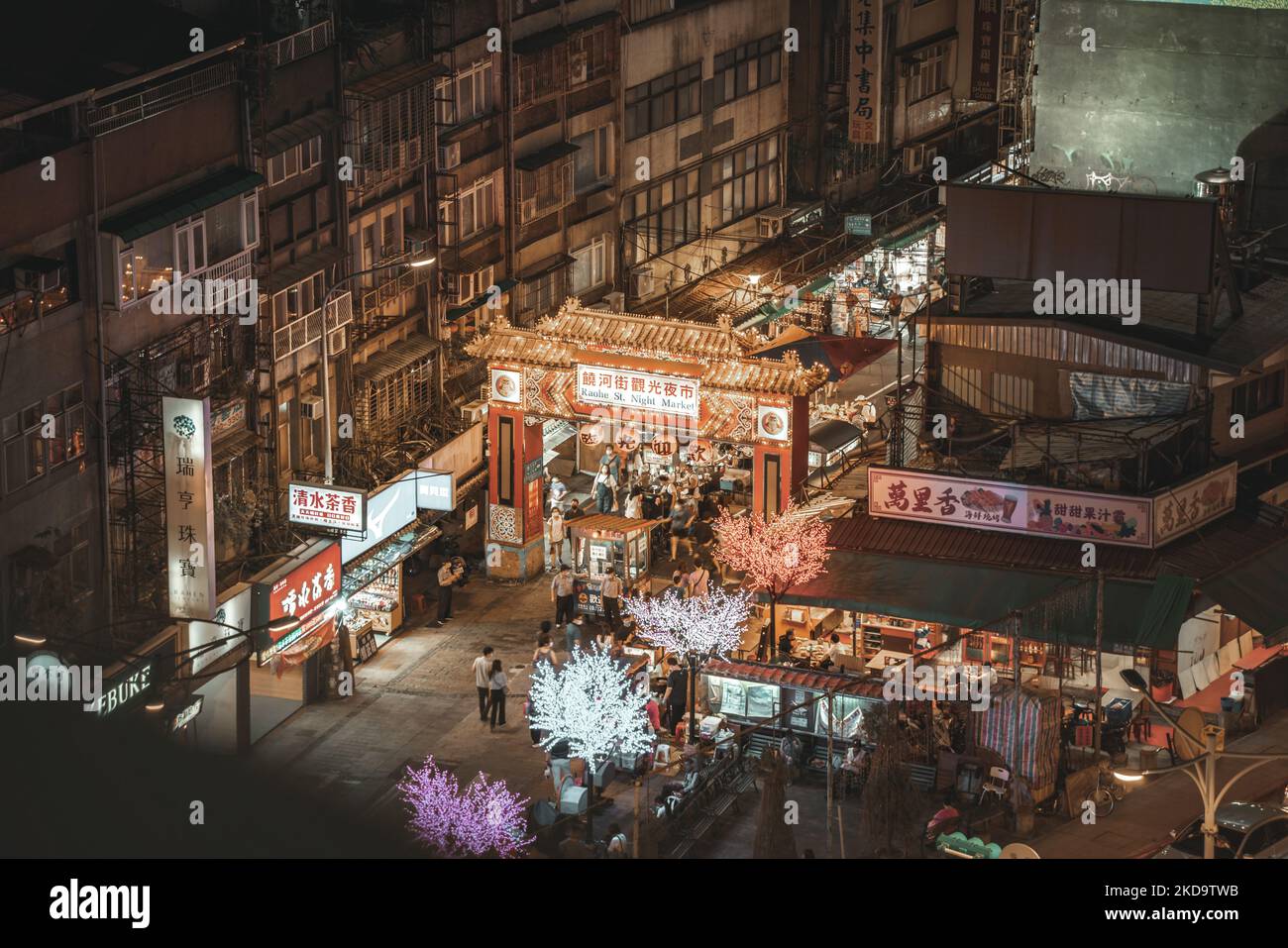 A high angle of Taiwan's night market and Songshan Ciyou temple ...