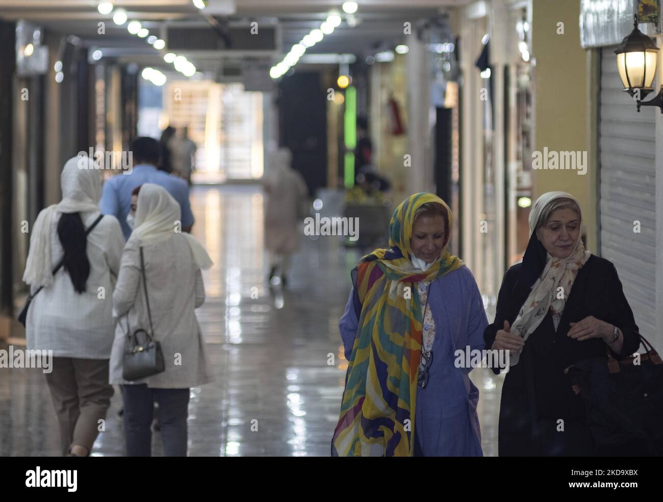 Iranian women walk along a shopping center in the Ekbatan town in the ...