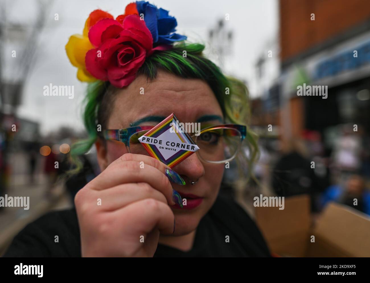 An activist holds a sign 'Pride Corner On Whyte'. More than 100 local ...