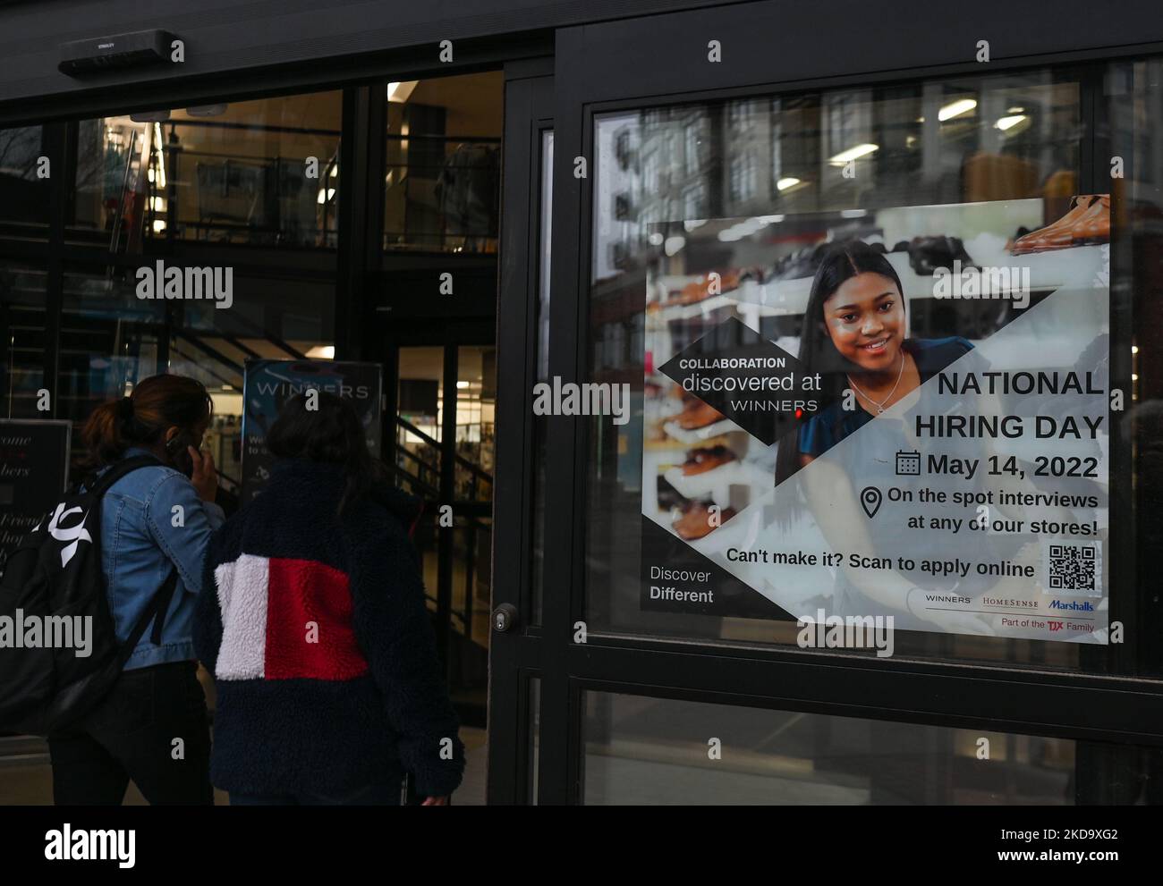 A poster 'National Hiring Day' seen at the entrance to a store in ...