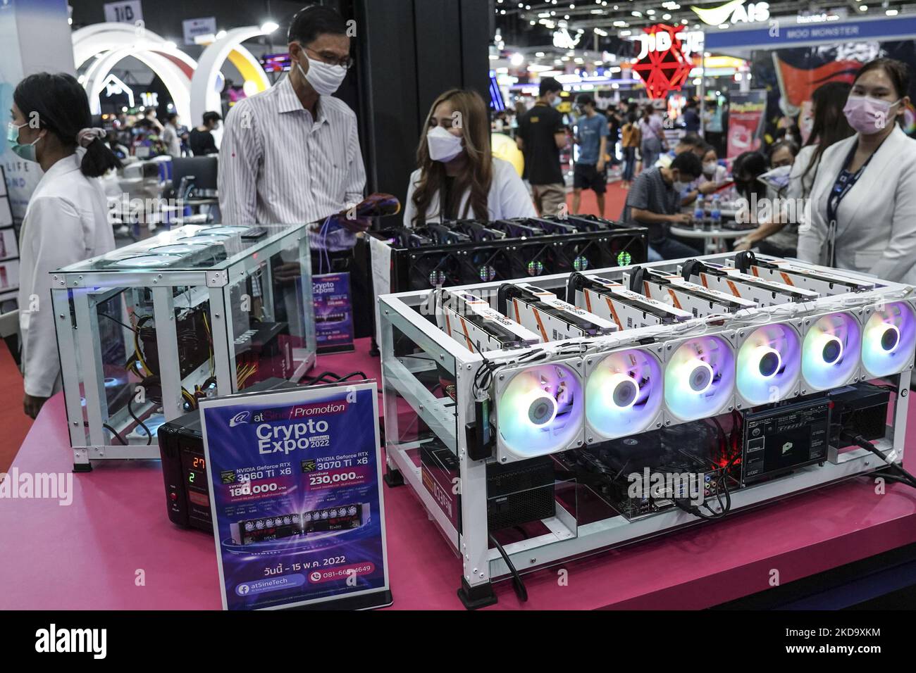 Visitors inspect crypto mining equipment at the Thailand Crypto Expo in ...