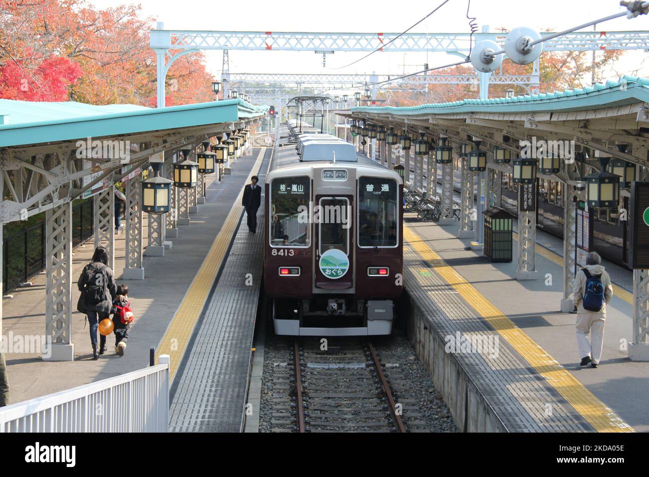 A train operating at Hankyu Railway train stop of Arashiyama Station ...