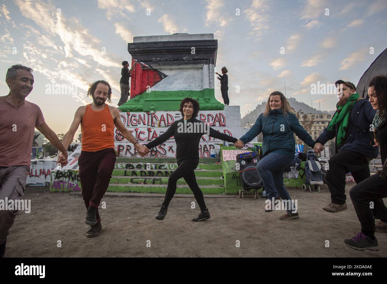 Persons dance Dabke (traditional Palestinian dance), in front of the ...
