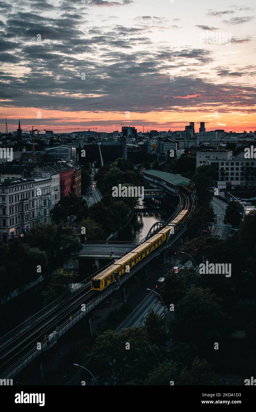 An aerial view of train on railway surrounded by buildings in Berlin ...