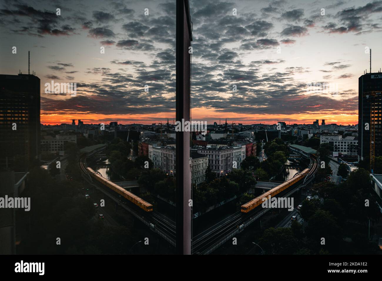 An aerial view of train on railway surrounded by buildings in Berlin ...