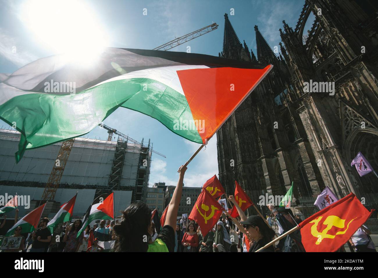 about a hundred protesters gather in front of Dom Cathedral in Cologne ...