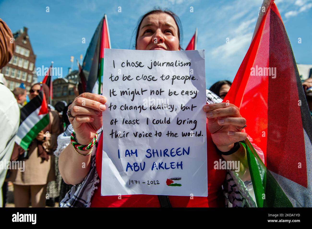 A woman is holding a text of Palestinian-American journalist Shireen ...
