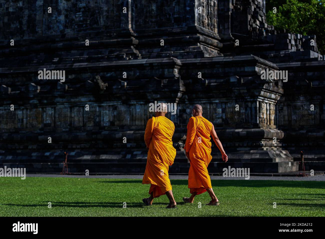 Buddhist monks walk around Mendut temple during the holy water ceremony ...