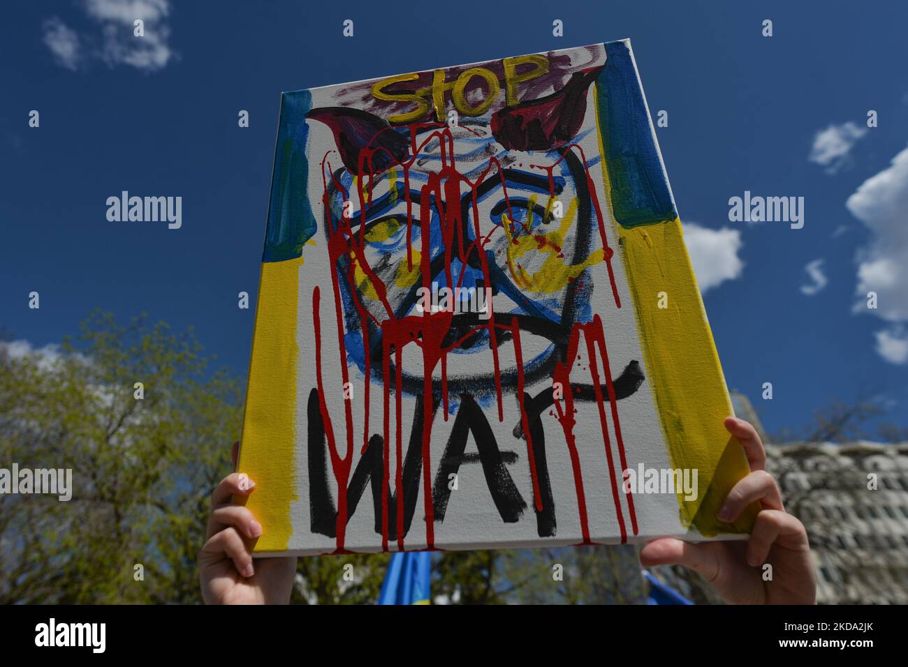 A young Ukrainian refugee, Sofiya, holds a picture she has painted ...