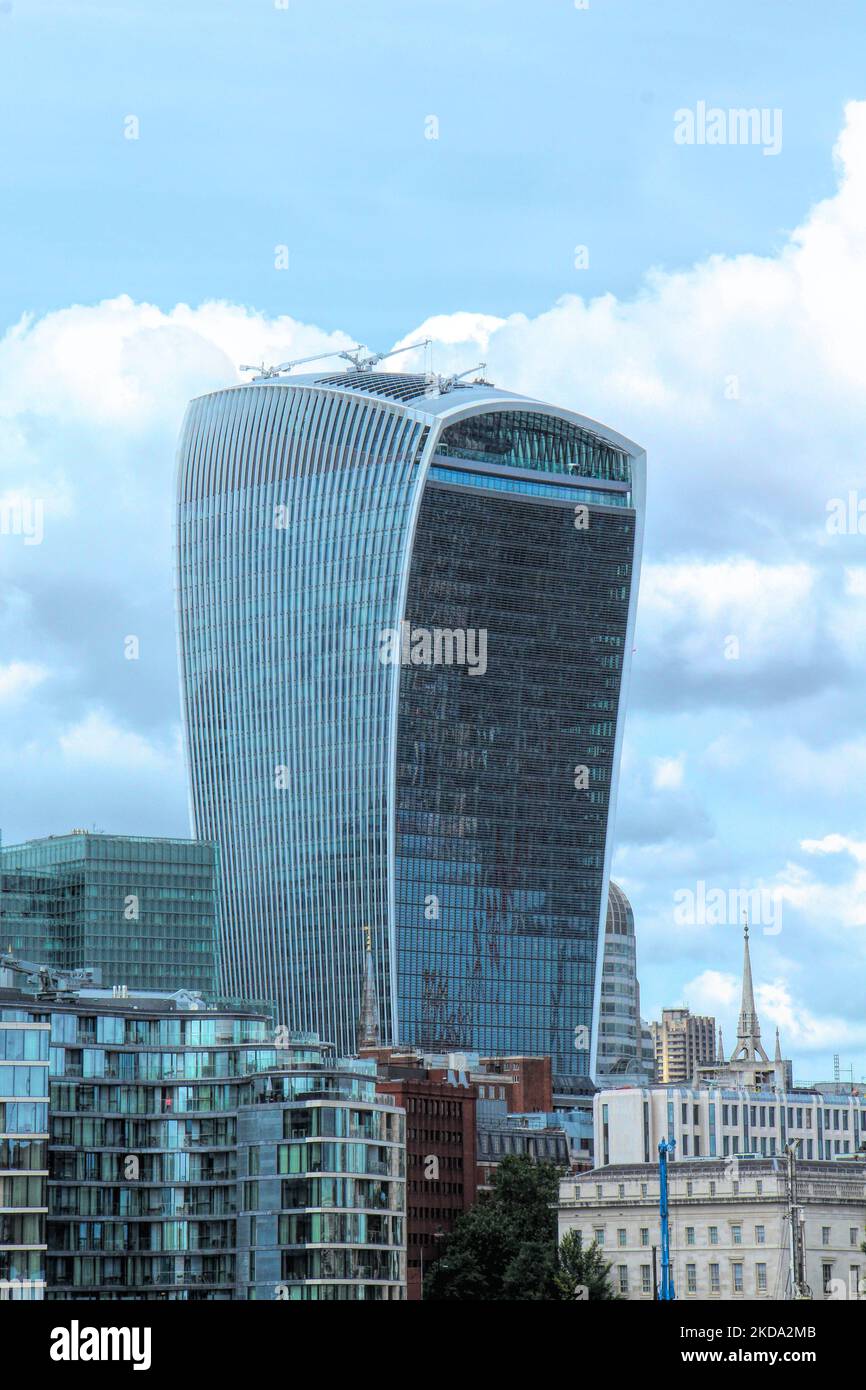 The famous Walkie Talkie building against the blue sky with clouds in ...
