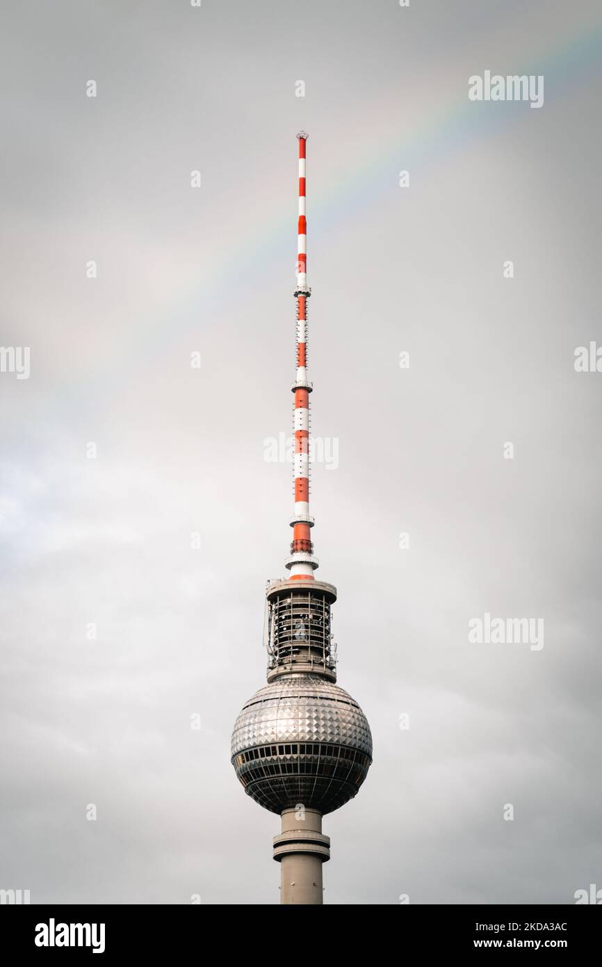 A vertical shot of TV tower against a cloudy sky in Berlin, Germany ...