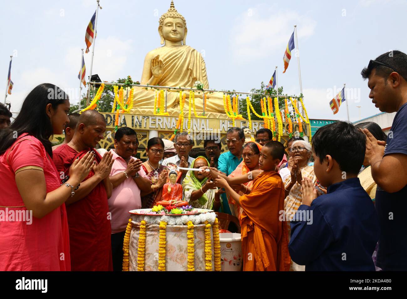 Indian Buddhist devotees pray at a statue of the Buddha during Buddha ...