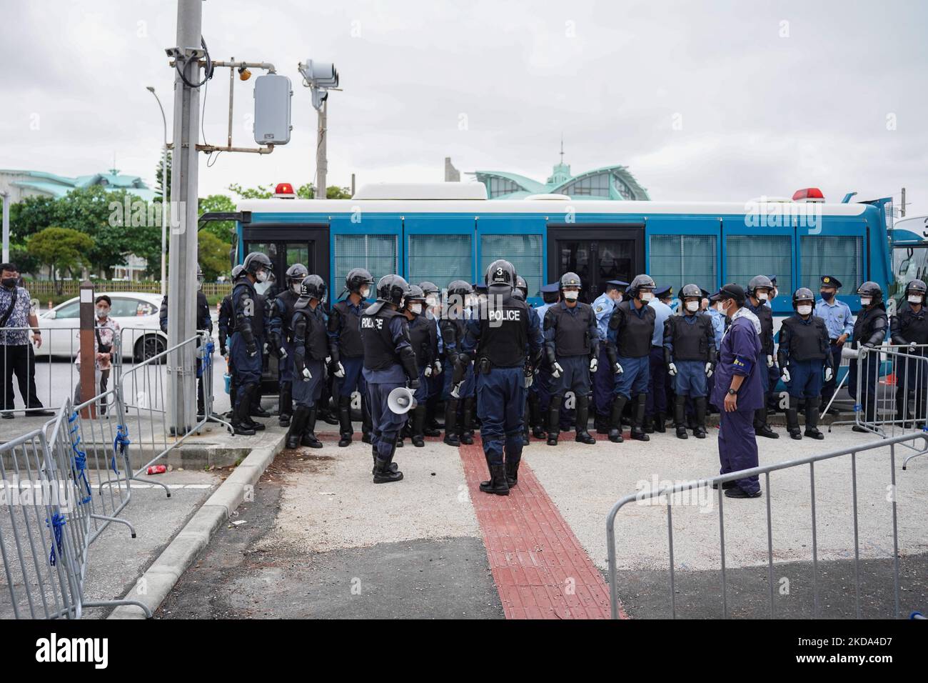 Japanese riot police prepares at barricades around Okinawa Convention ...