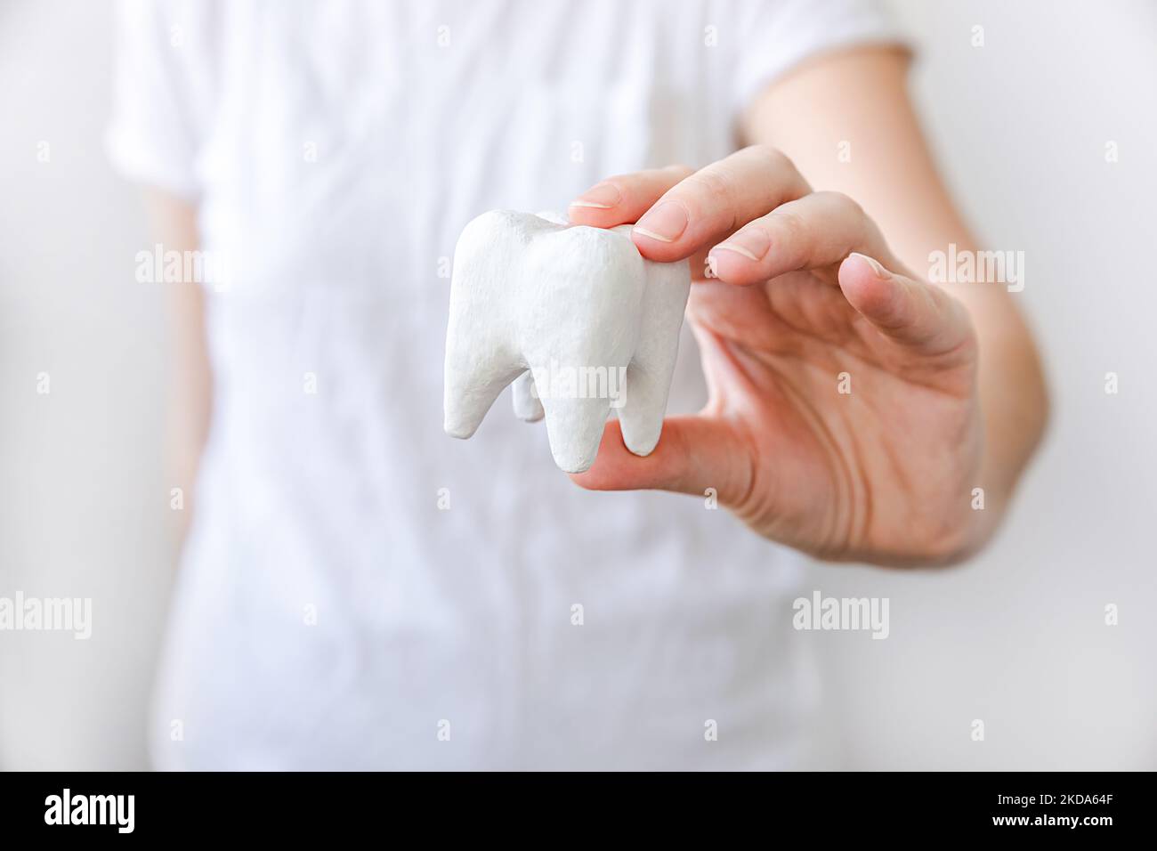 Health dental care concept. Woman hand holding white healthy tooth ...