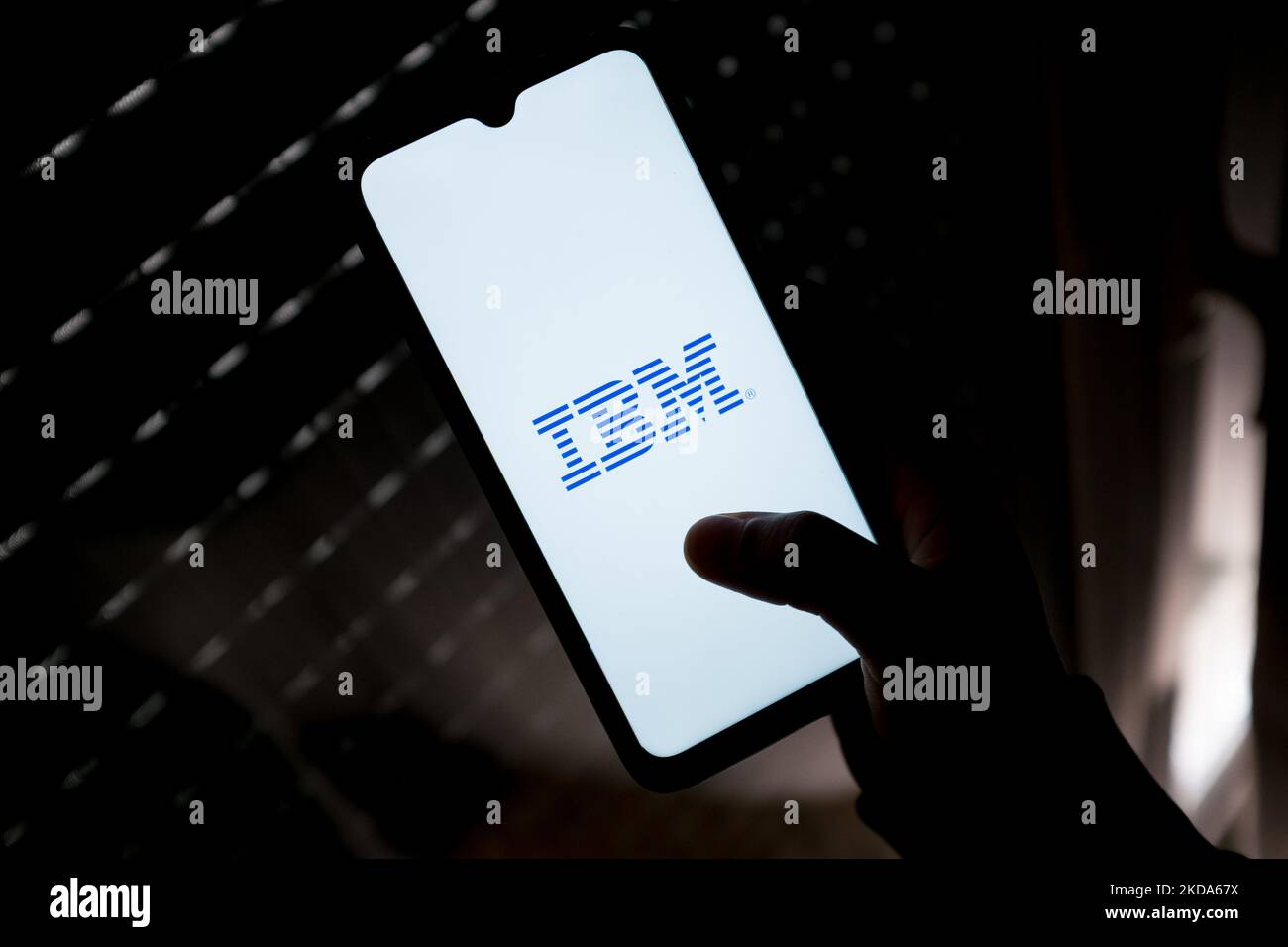 In this photo illustration an IBM logo seen displayed on a smartphone ...