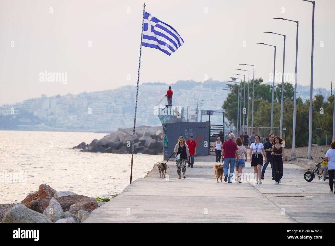 Members of the public walk along the promenade in Athens on 17 May 2022 ...