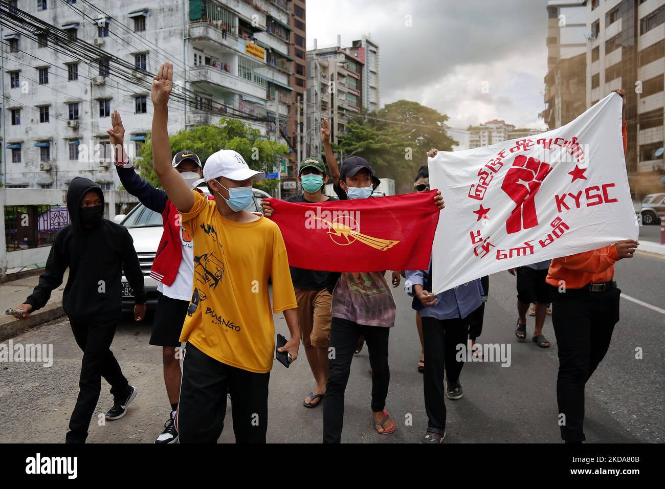 Young demonstrators shout slogans and make the defiant three-finger ...