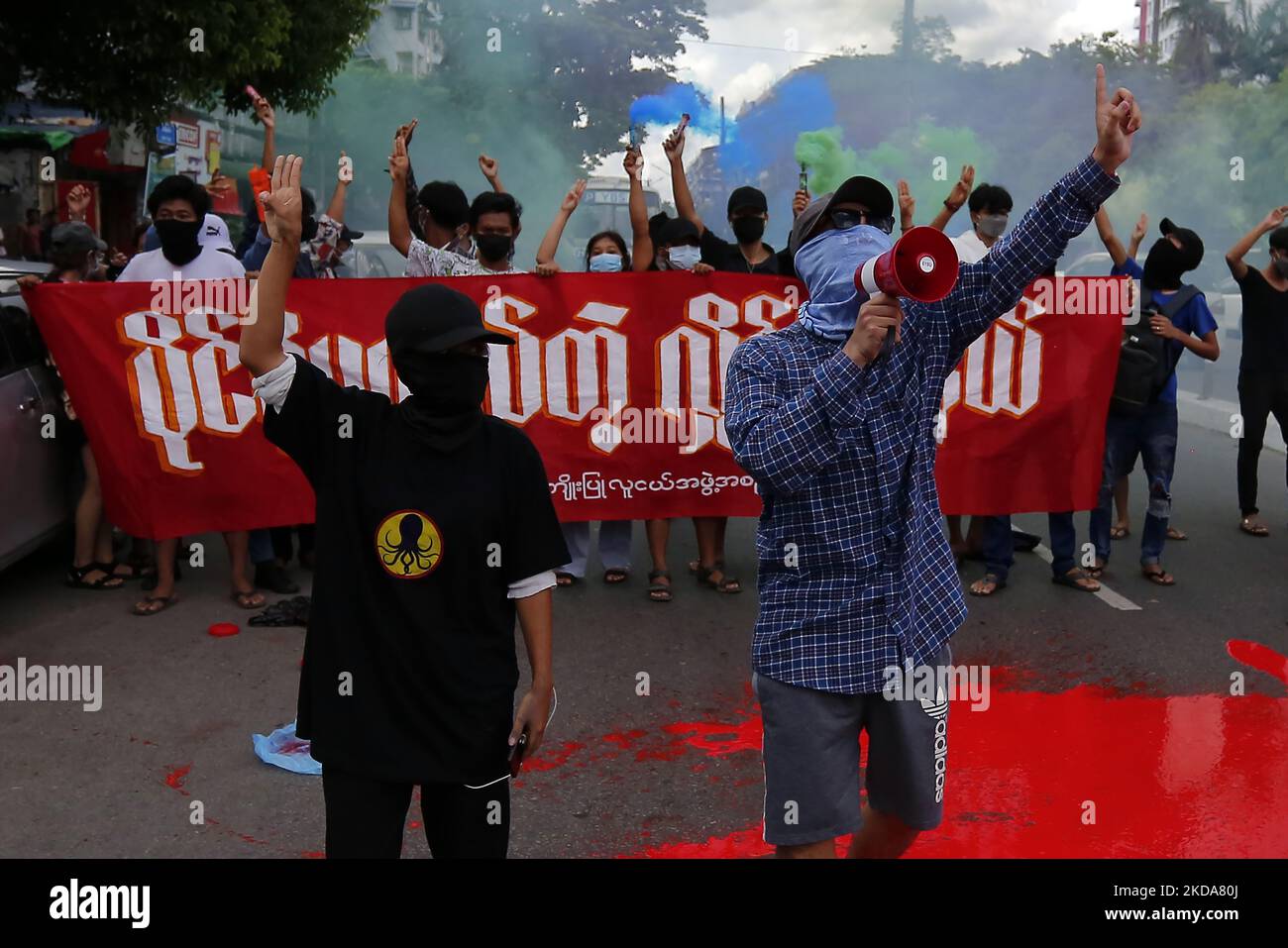 Young demonstrators shout slogans and make the defiant three-finger ...