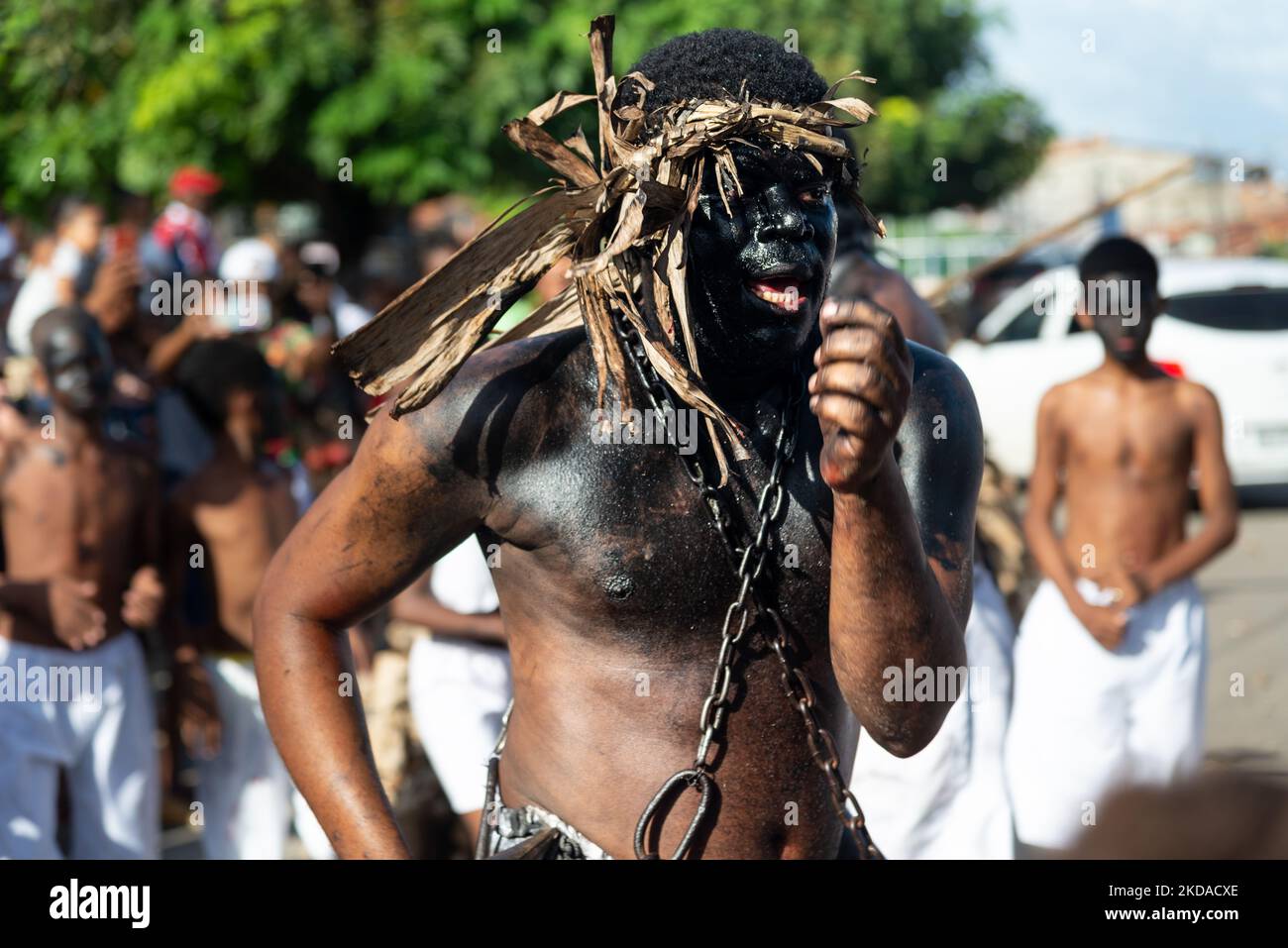 Members of the cultural event Nego Fugido sing and sit on the ground ...