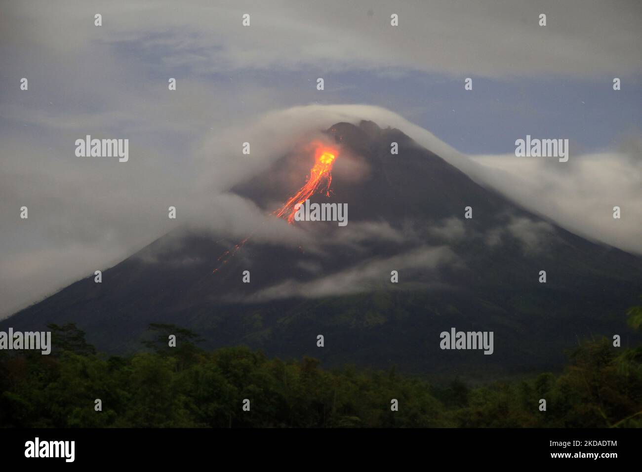 Lava spews from the peak of Merapi volcano during its effusive ...