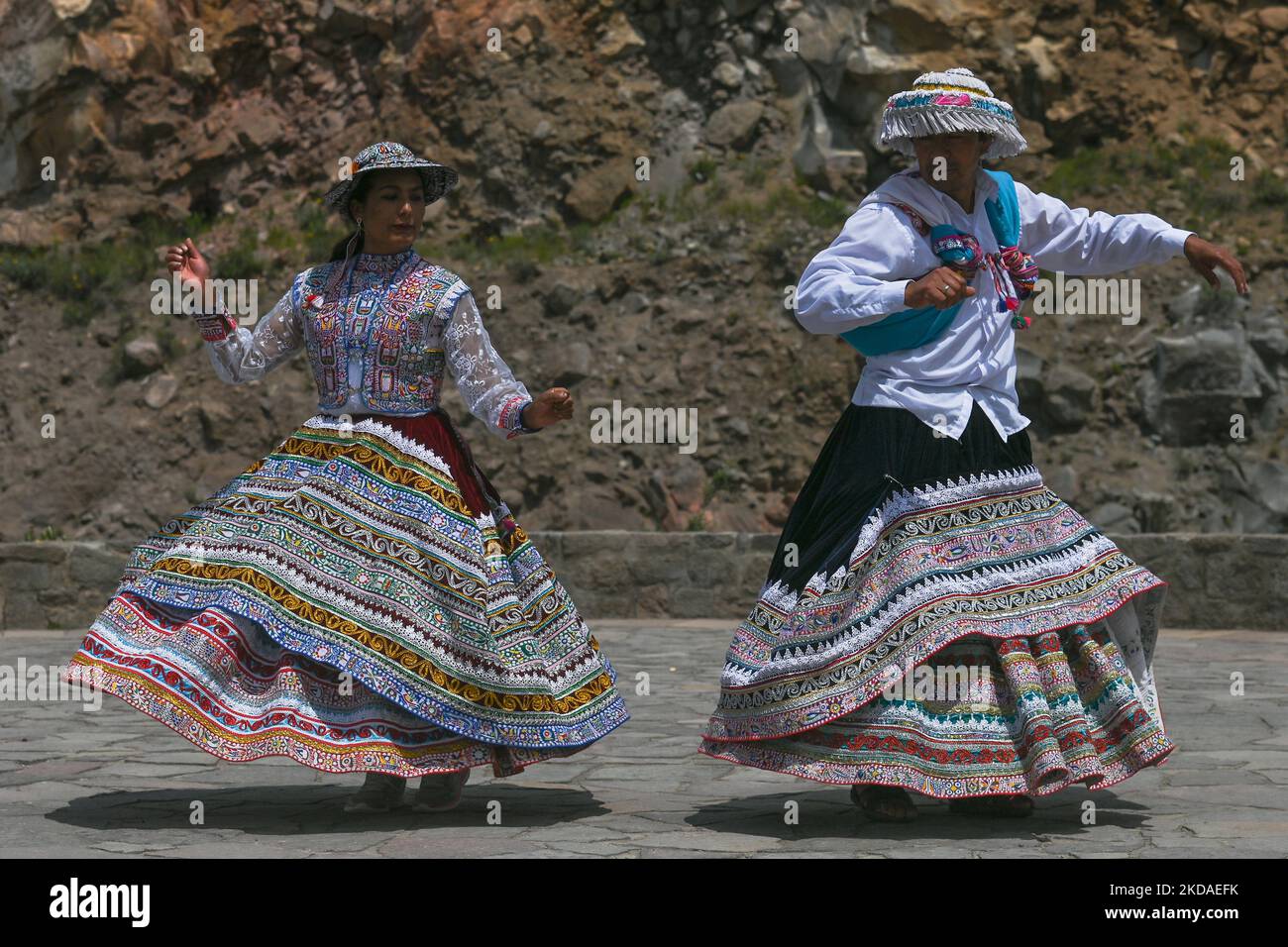 Local dancers wearing traditional local dresses and hats perform local ...